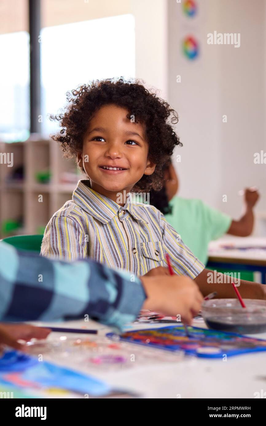 Classroom Portrait Of Smiling Male Elementary School Pupil In Art Class ...