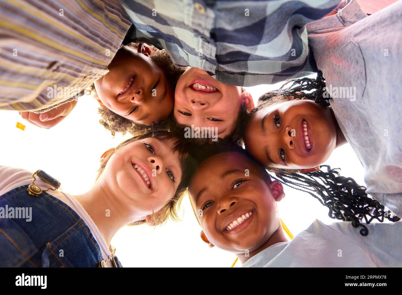 Low Angle Portrait Of Smiling Multi-Cultural Children Looking Down Into ...