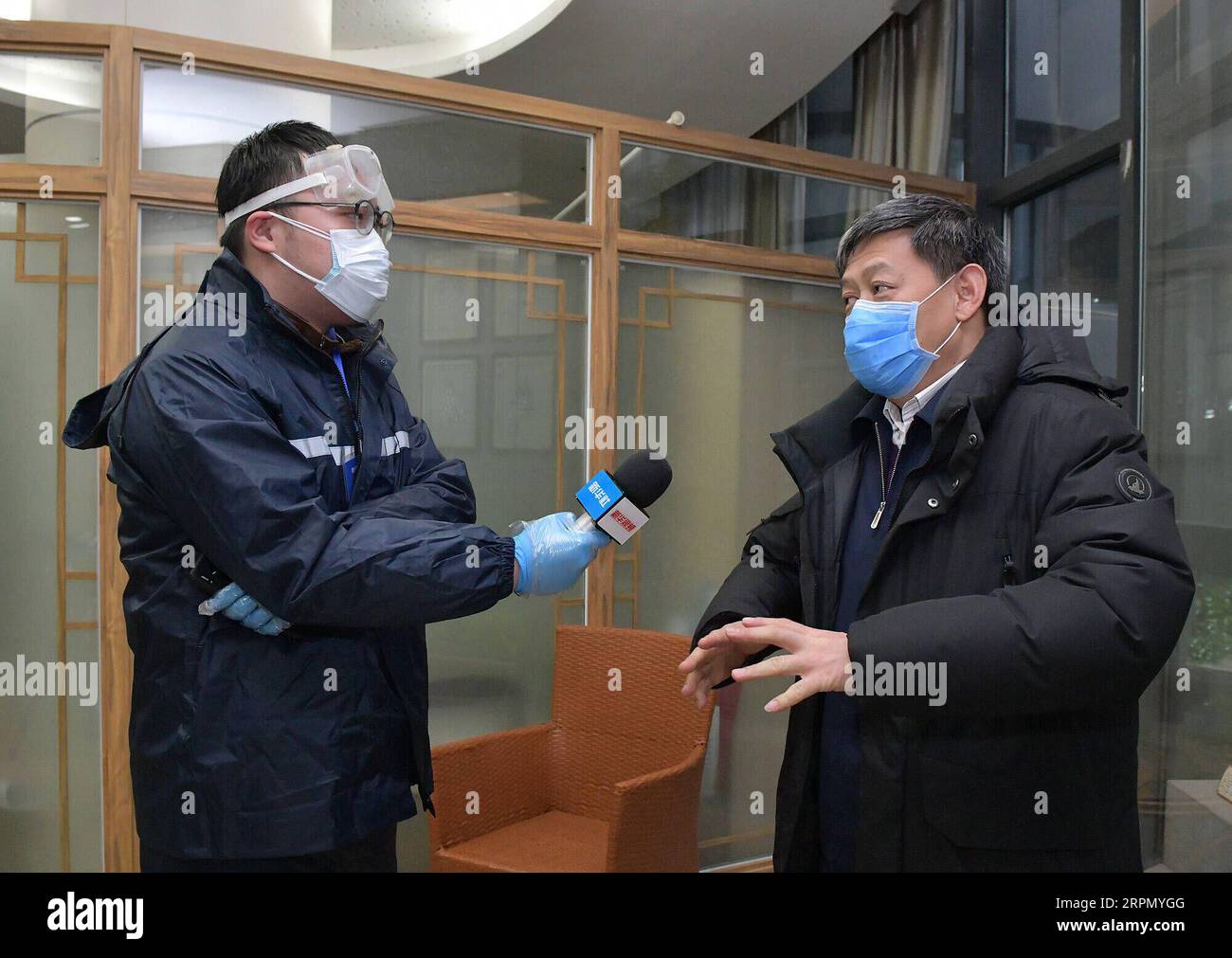 200219 -- WUHAN, Feb. 19, 2020 -- Xinhua News Agency journalist Hu Zhe L interviews Liu Qingquan ...