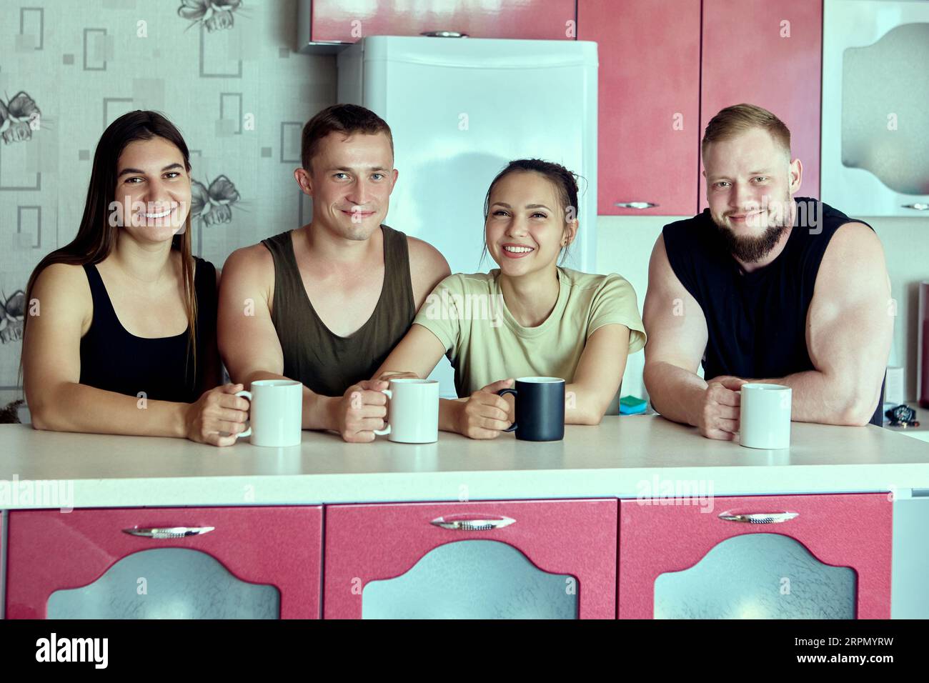 Two married couples met in kitchen of rented house, group portrait ...