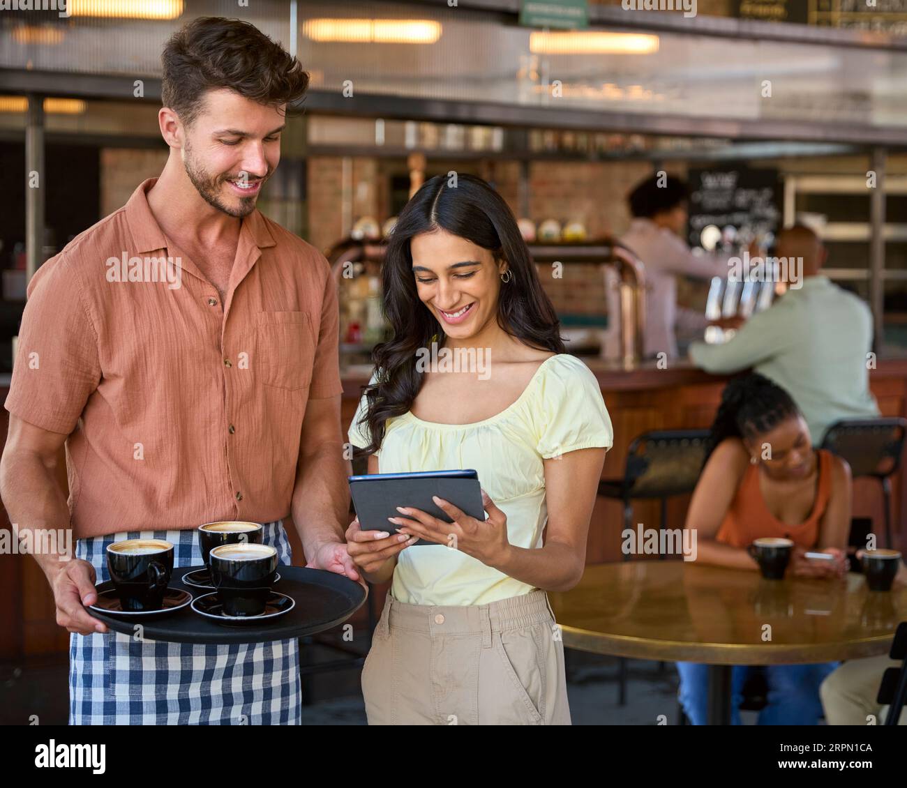 Female Manager With Digital Tablet And Waiter Working In Restaurant Or ...