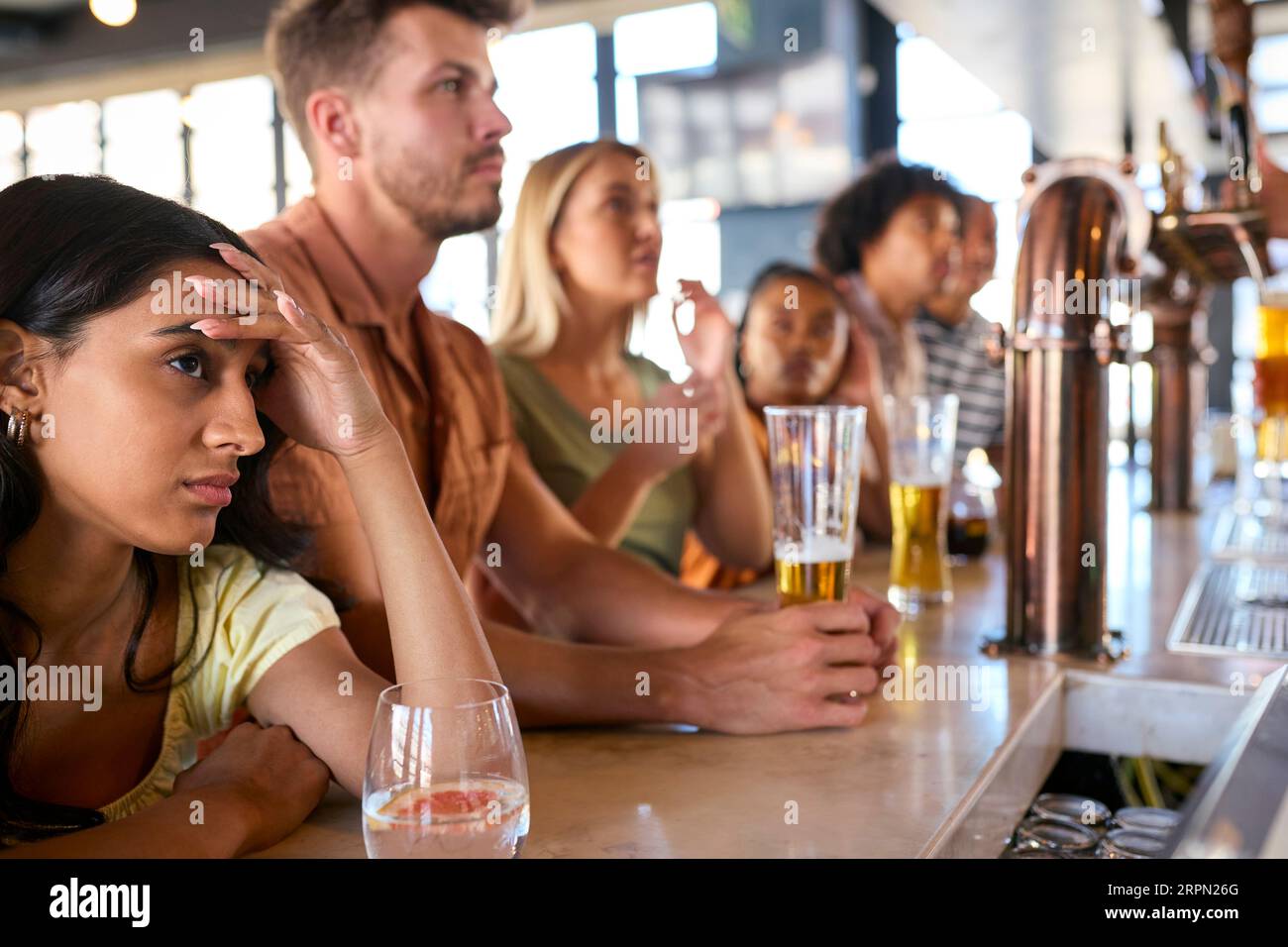 Disappointed Multi-Cultural Group Of Friends In Sports Bar Watching ...