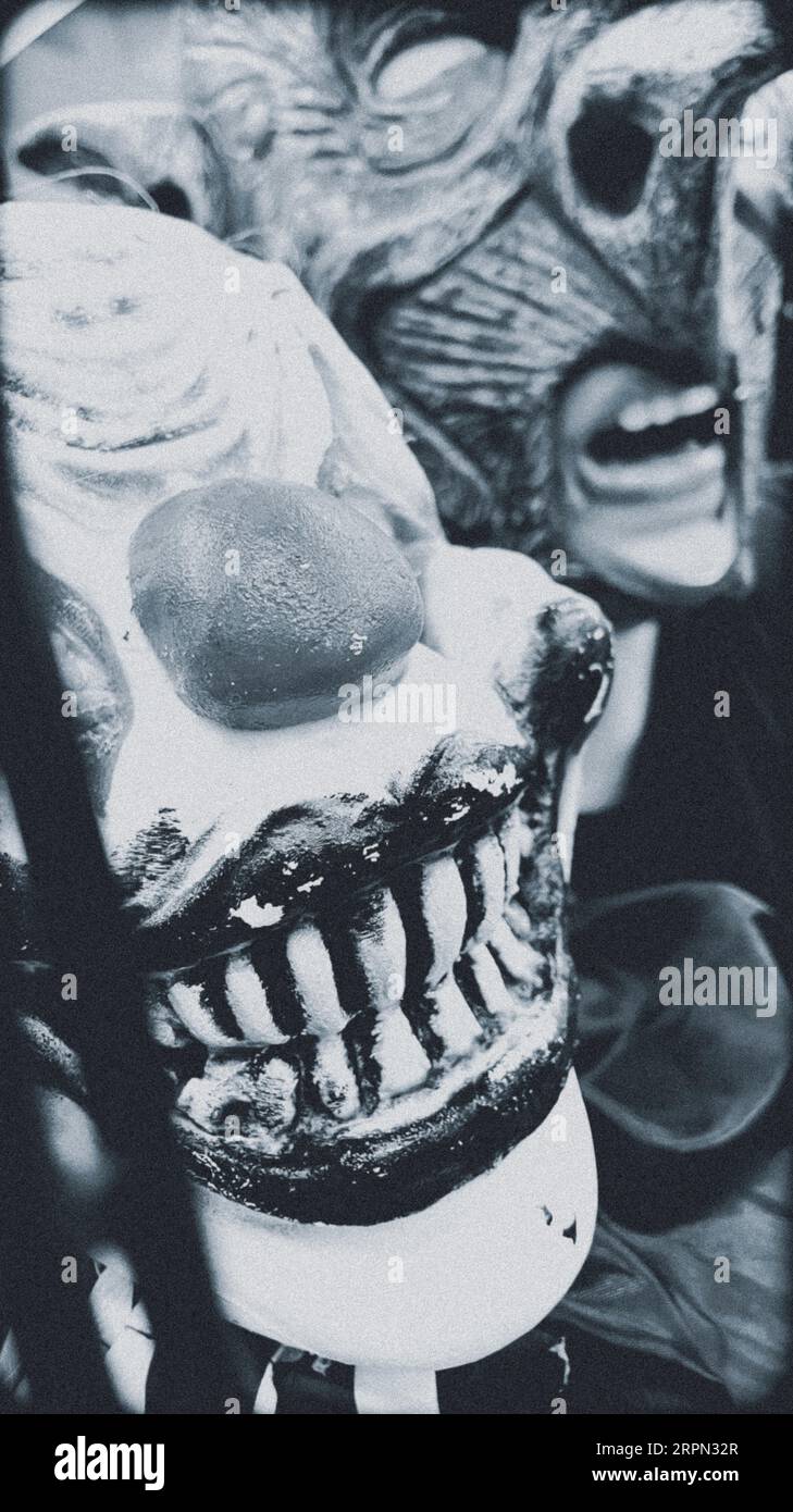 A black and white photograph featuring an array of spooky looking head ...