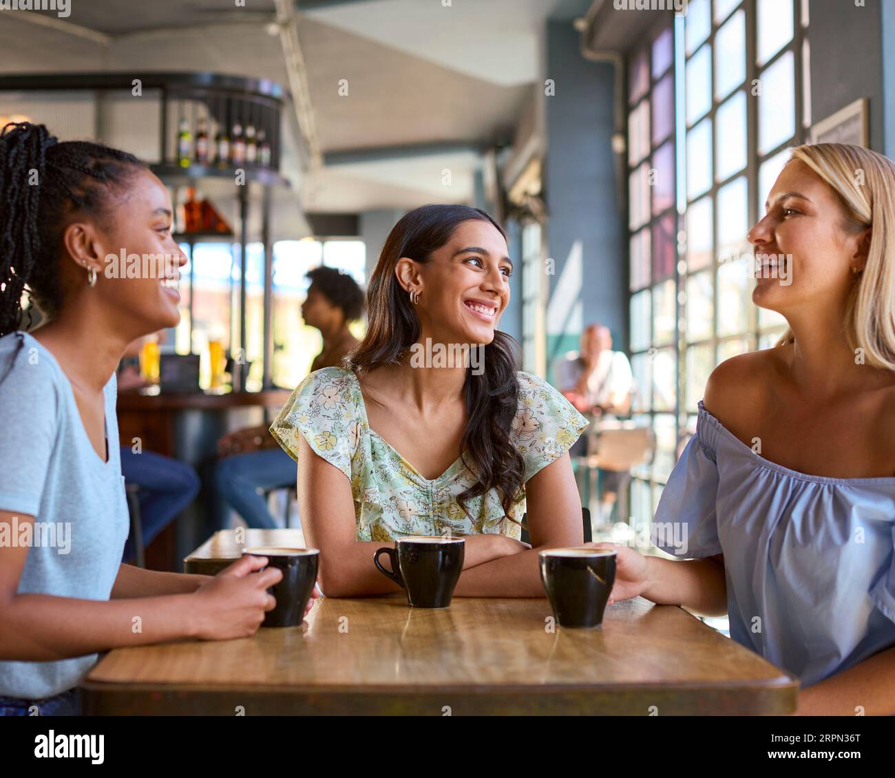 Multi-Cultural Group Of Female Friends Meeting And Catching Up In ...
