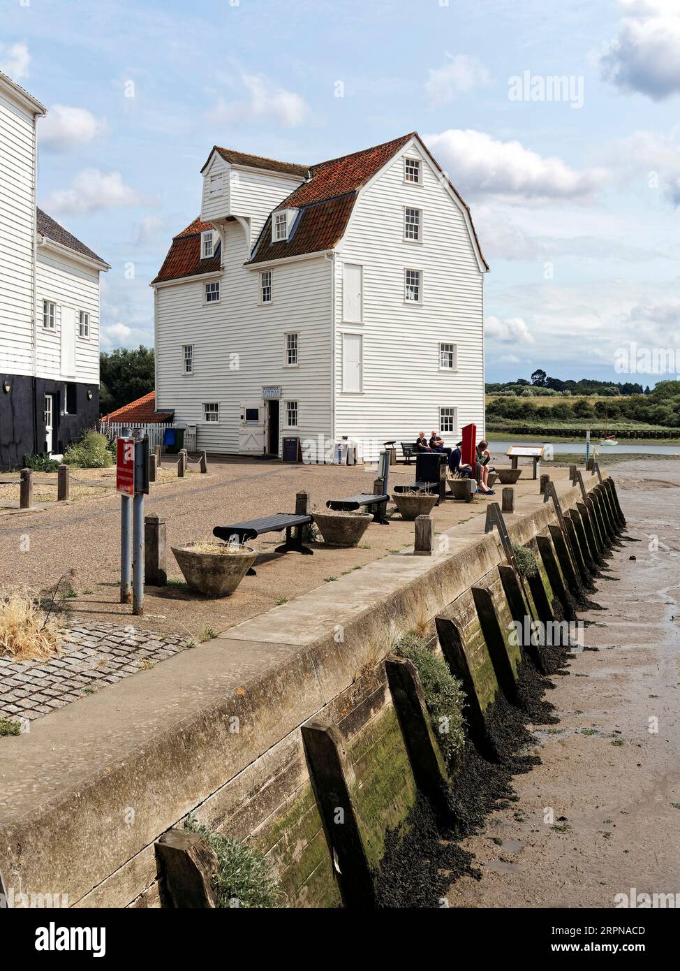 The famous tide mill at Woodbridge in Suffolk seen across the mud of ...