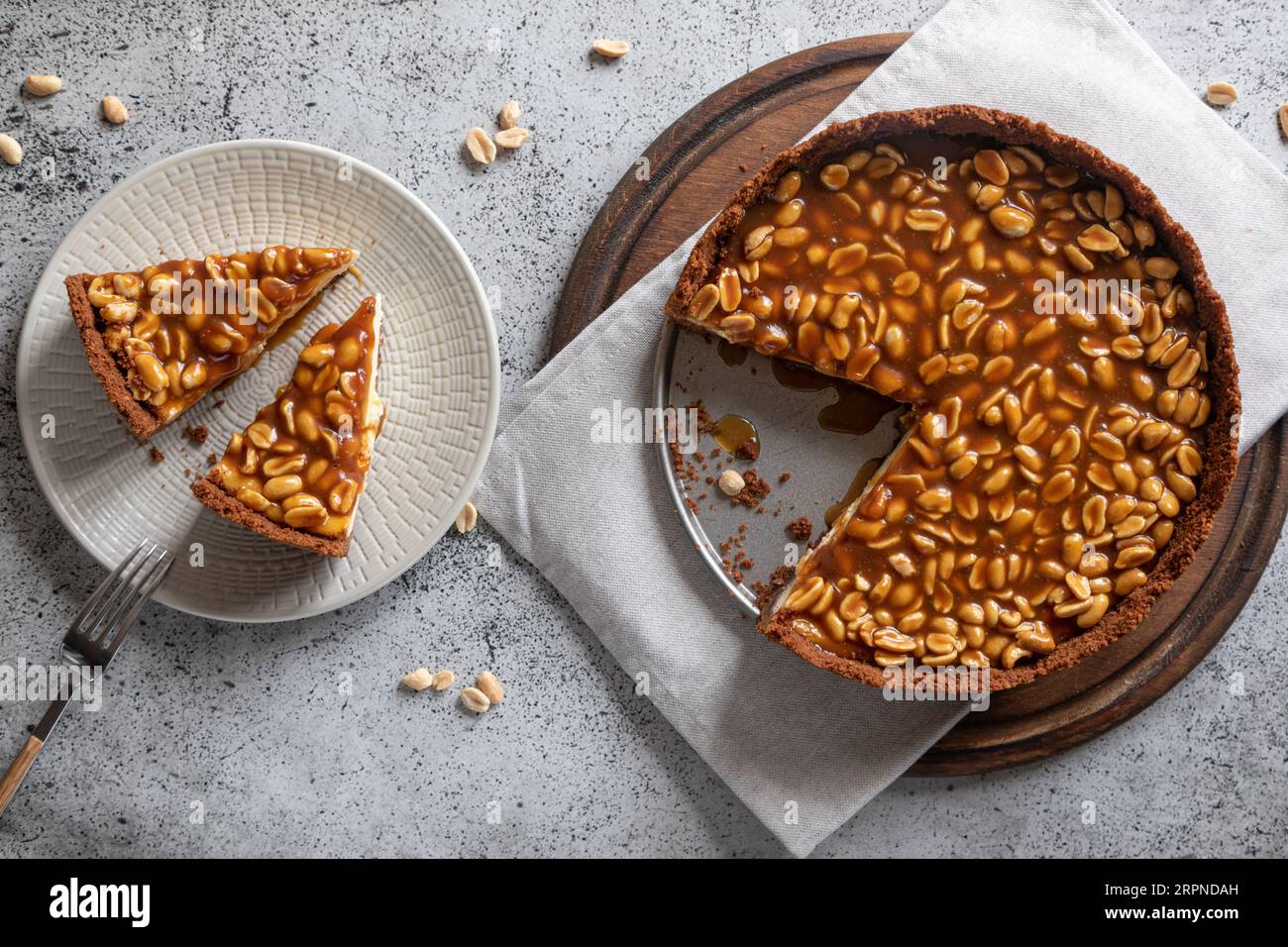 Homemade caramel-peanut cheesecake on a light background. Morning ...