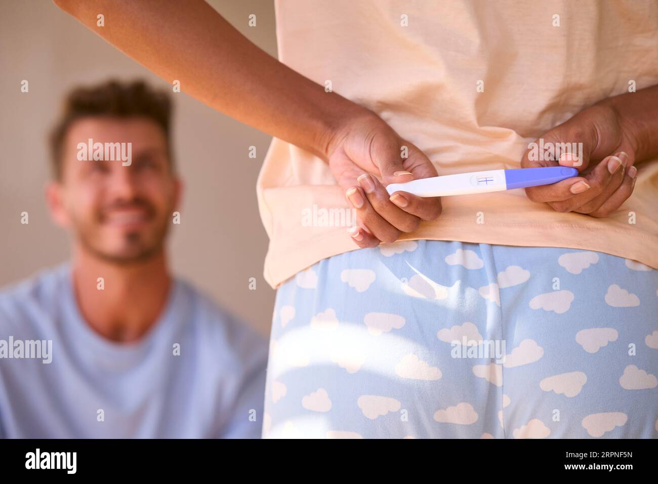 Woman In Bedroom Hiding Positive Pregnancy Test Behind Back To Surprise ...