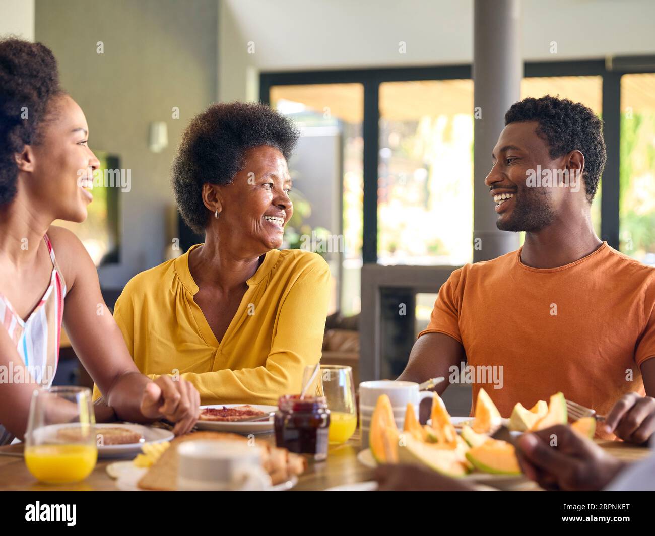 Family Shot With Senior Parents And Adult Offspring At Breakfast Around ...