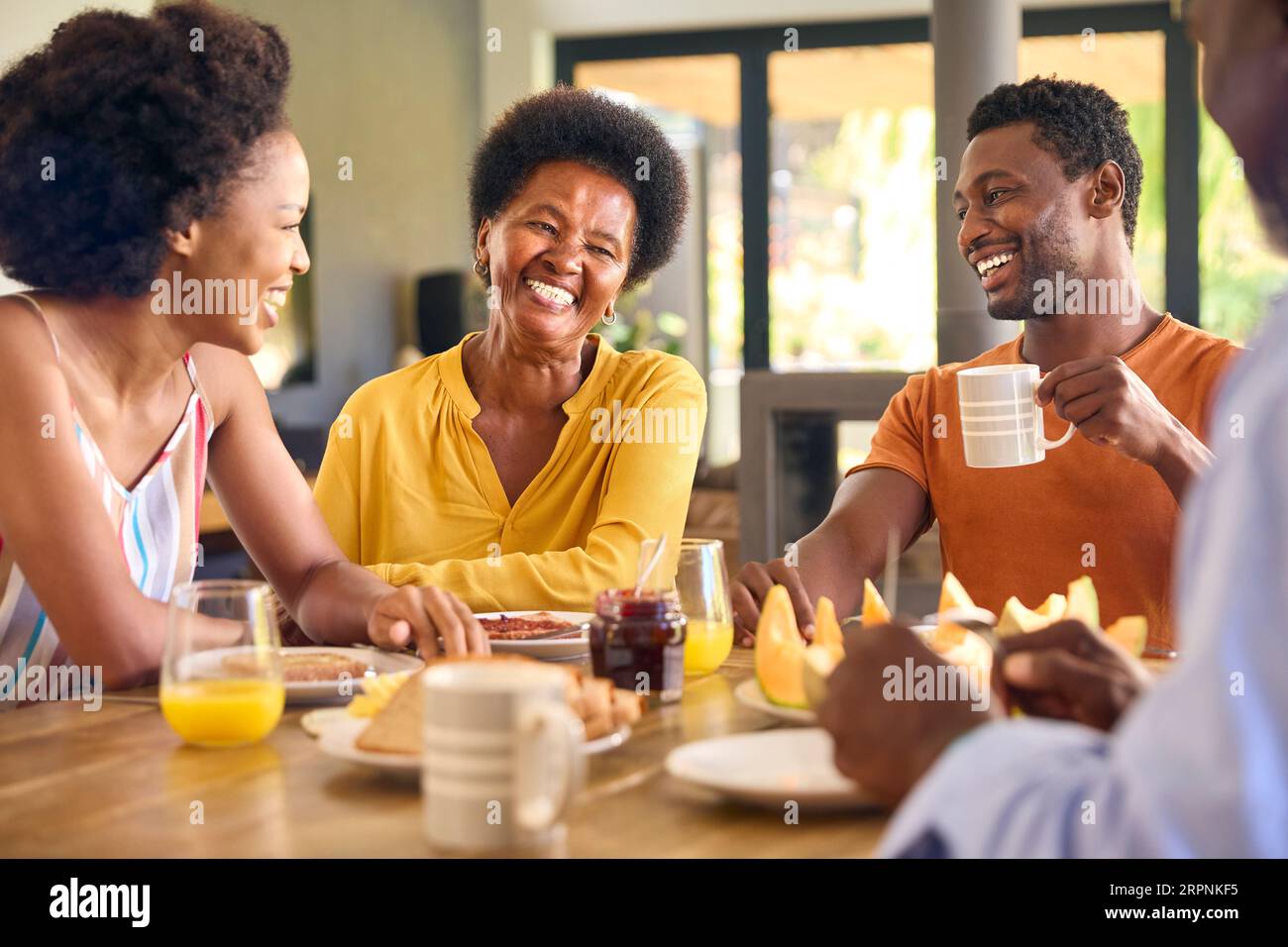Family Shot With Senior Parents And Adult Offspring At Breakfast Around ...