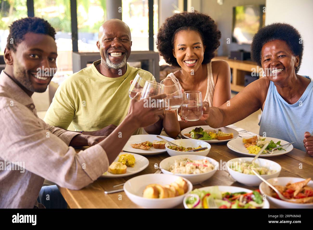 Portrait Of Family With Senior Parents And Adult Offspring Around Table ...
