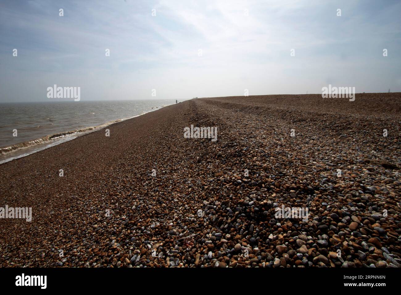 The shingle beach at the seas edge on the coast in Dungeness, Kent ...