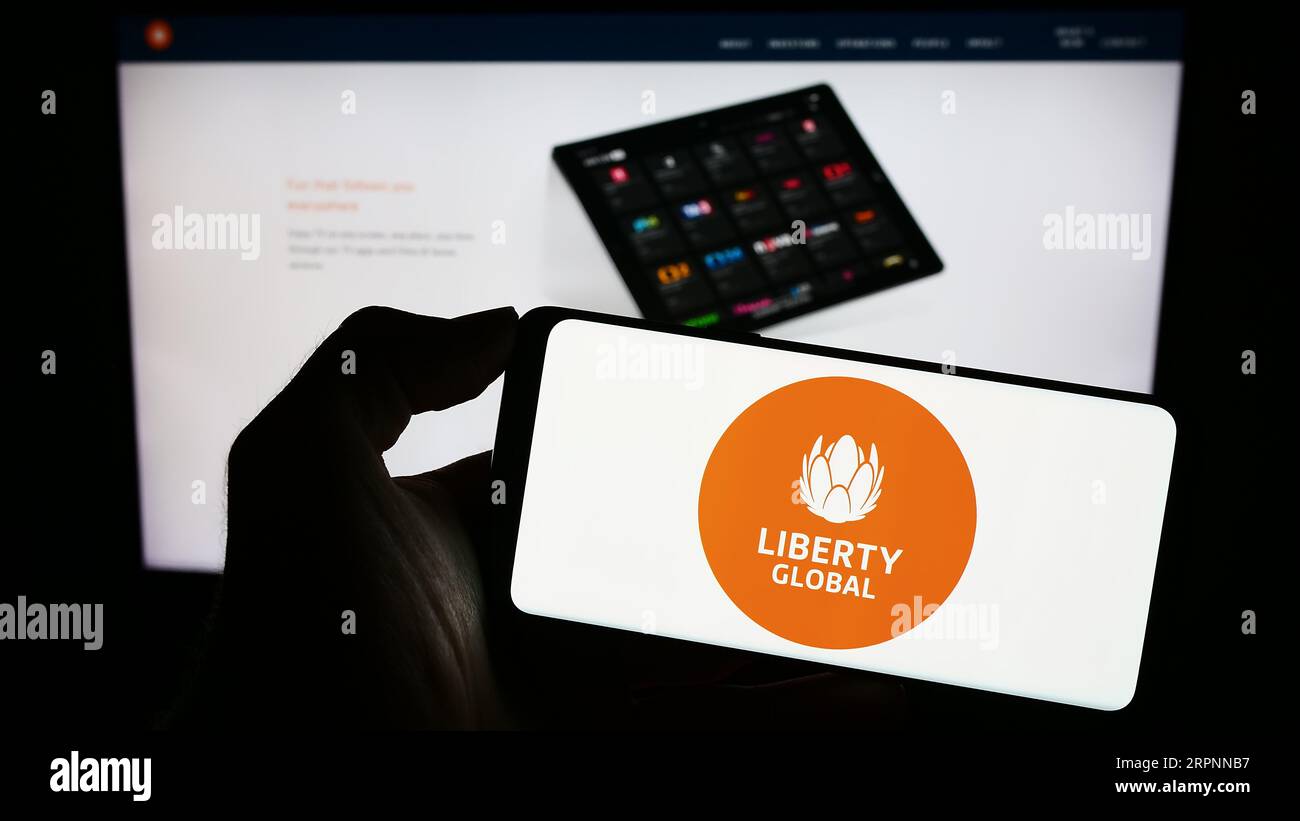 Person holding smartphone with logo of telecommunications company ...