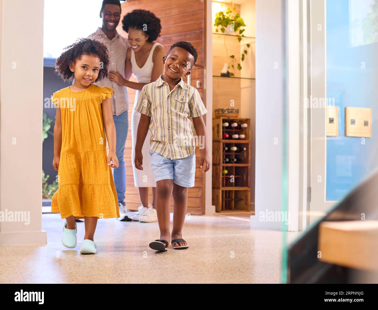 Family Returning Home Opening Front Door And Children Running In Stock ...