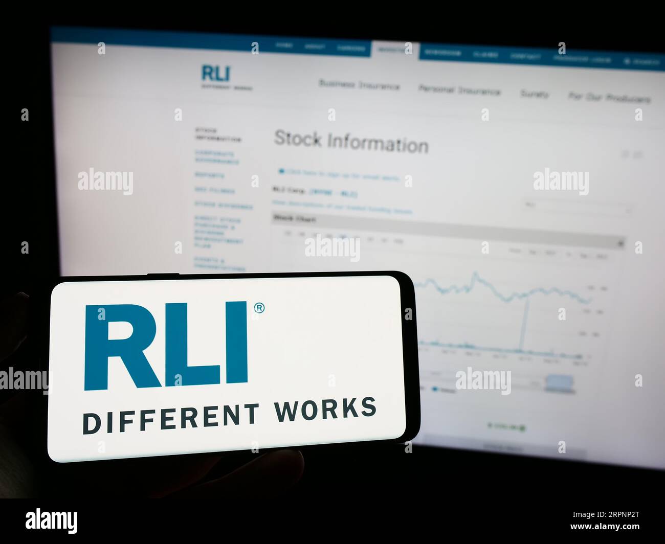 Person holding mobile phone with logo of American insurance company RLI ...