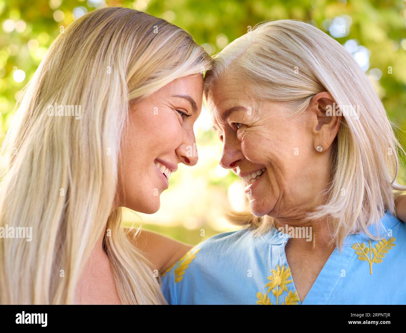 Multi-Generation Family With Senior Mother And Adult Daughter Laughing ...