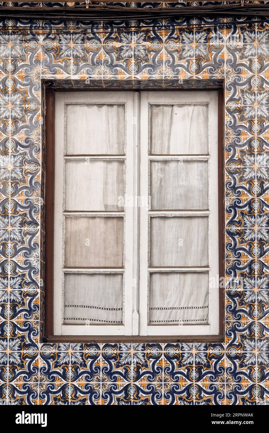 Close-up of old Portuguese window with traditional ceramic Azulejo ...