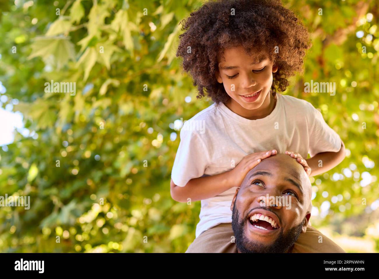 Child riding on dads shoulders hi-res stock photography and images - Alamy