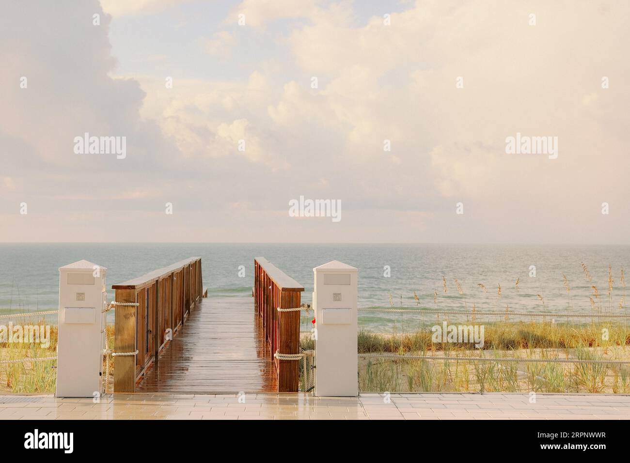 A scenic wooden bridge leads visitors from a deck to Orange Beach in ...