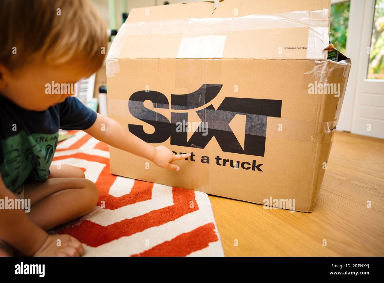 Bremen, Germany - Aug 14, 2023: A young child points to sixt Rent a ...