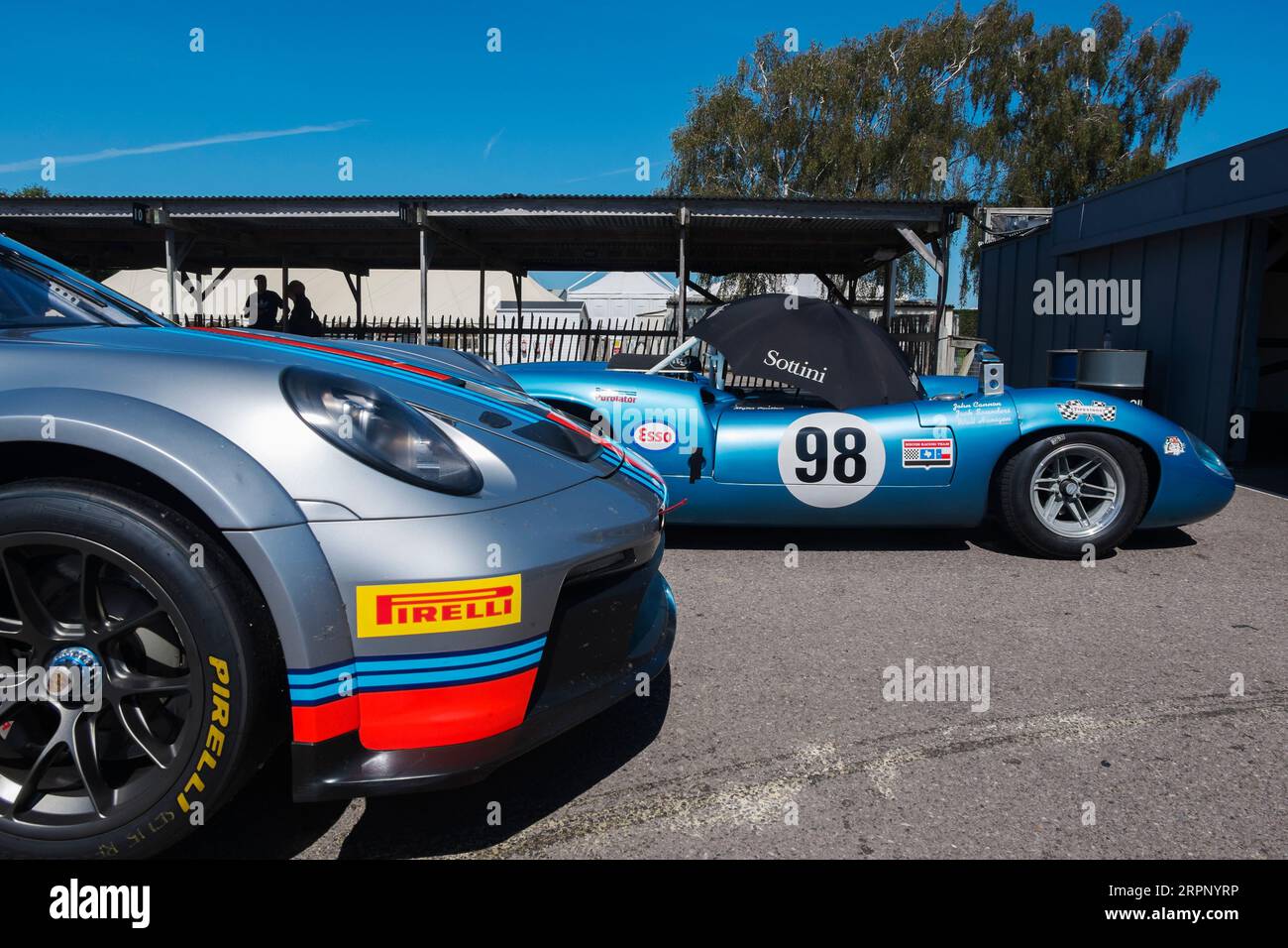 Martini Porsche 911 GT3 & 1960s Lola Mk1 T70 Spyder under an umbrella ...