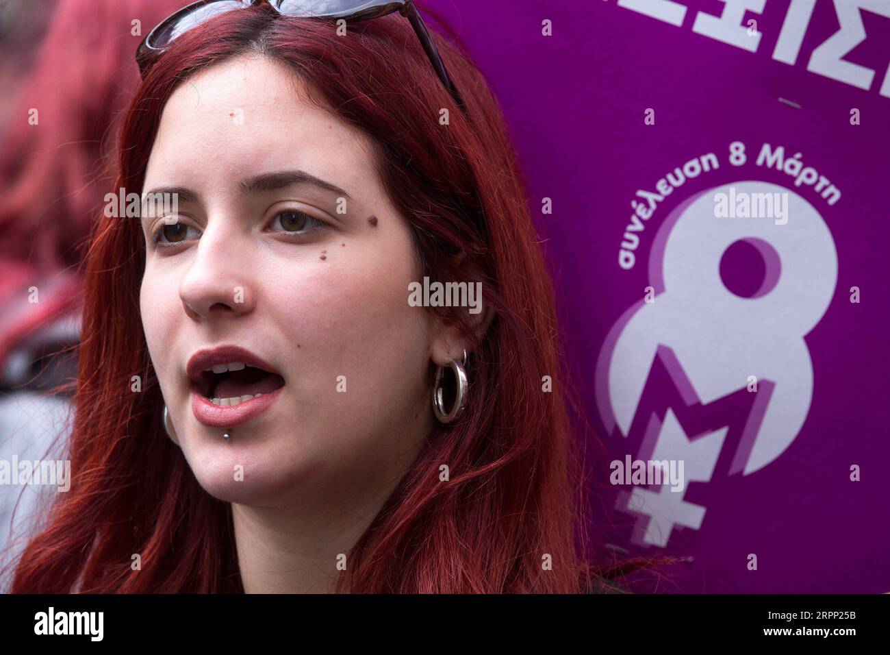 200308 -- ATHENS, March 8, 2020 -- A woman takes part in a march for ...