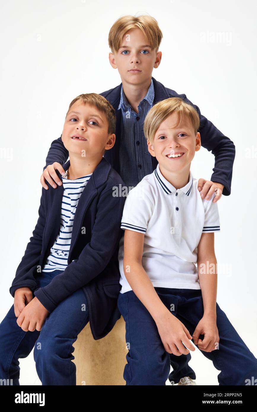 Boys, children, classmates in stylish school uniform against white ...