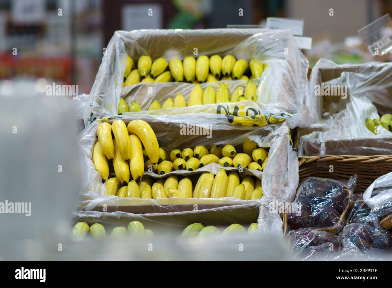 Bananas in the boxes in the supermarket. Healthy food. shopping concept ...