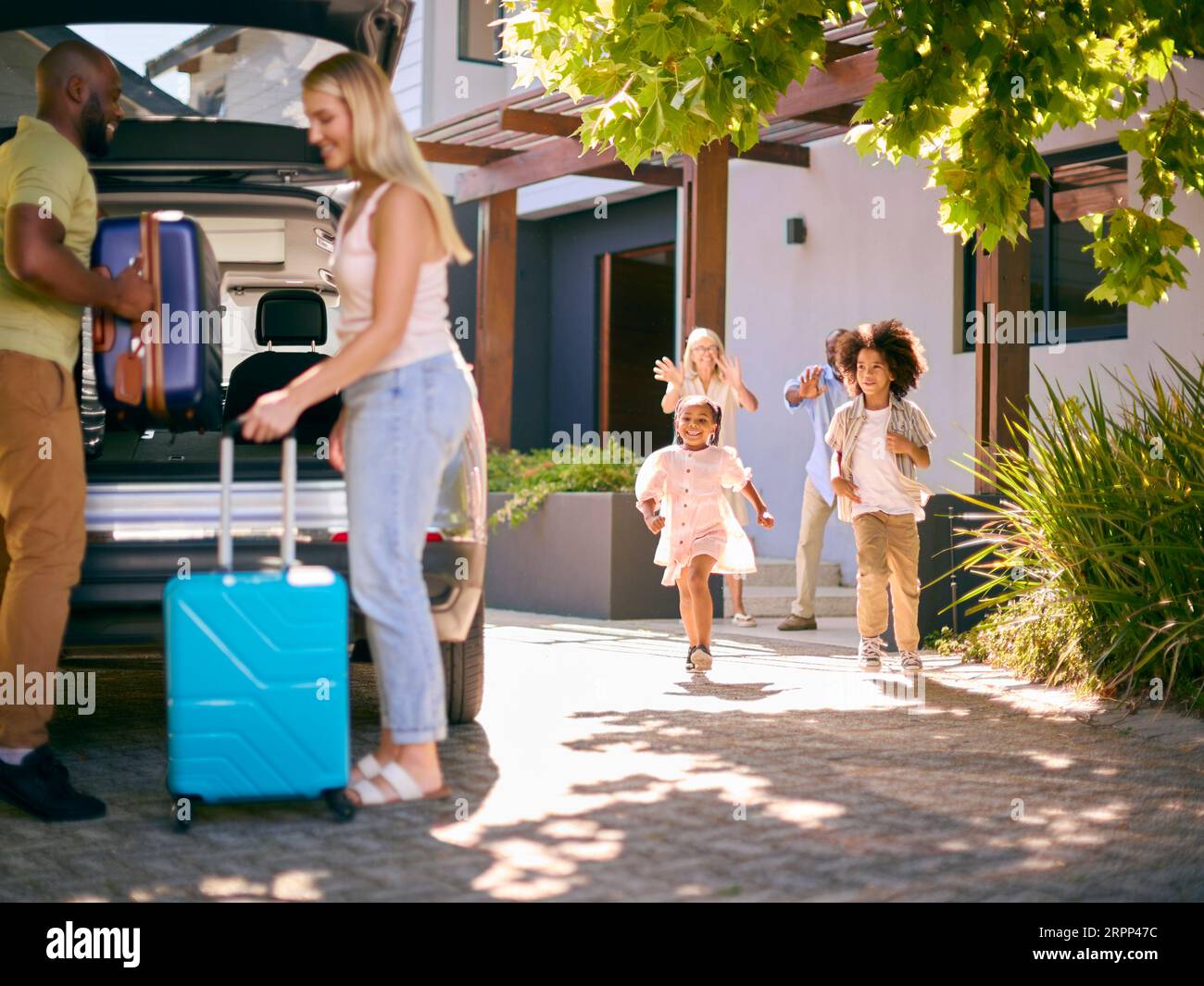 Family Loading Car And Saying Goodbye After Visit To Grandparents Stock ...