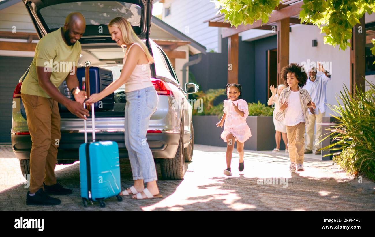 Family Loading Car And Saying Goodbye After Visit To Grandparents Stock ...
