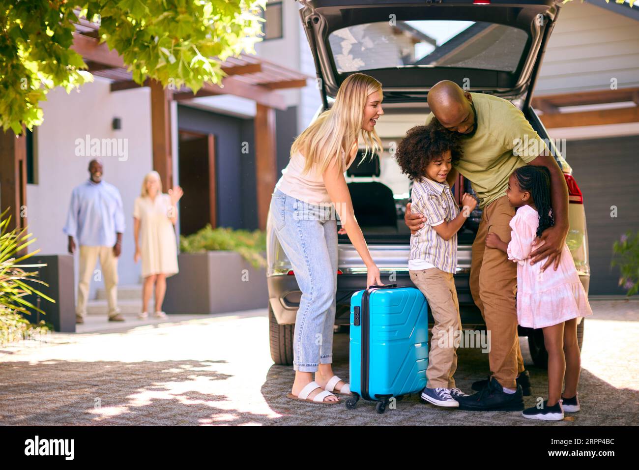 Family Loading Car And Saying Goodbye After Visit To Grandparents Stock ...