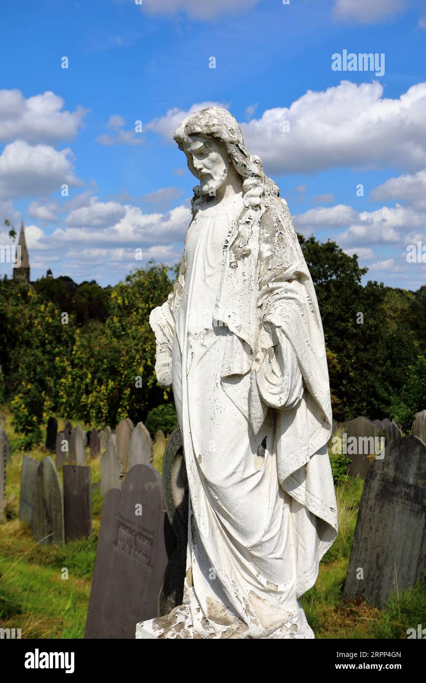 a weathered statue in a graveyard Stock Photo - Alamy
