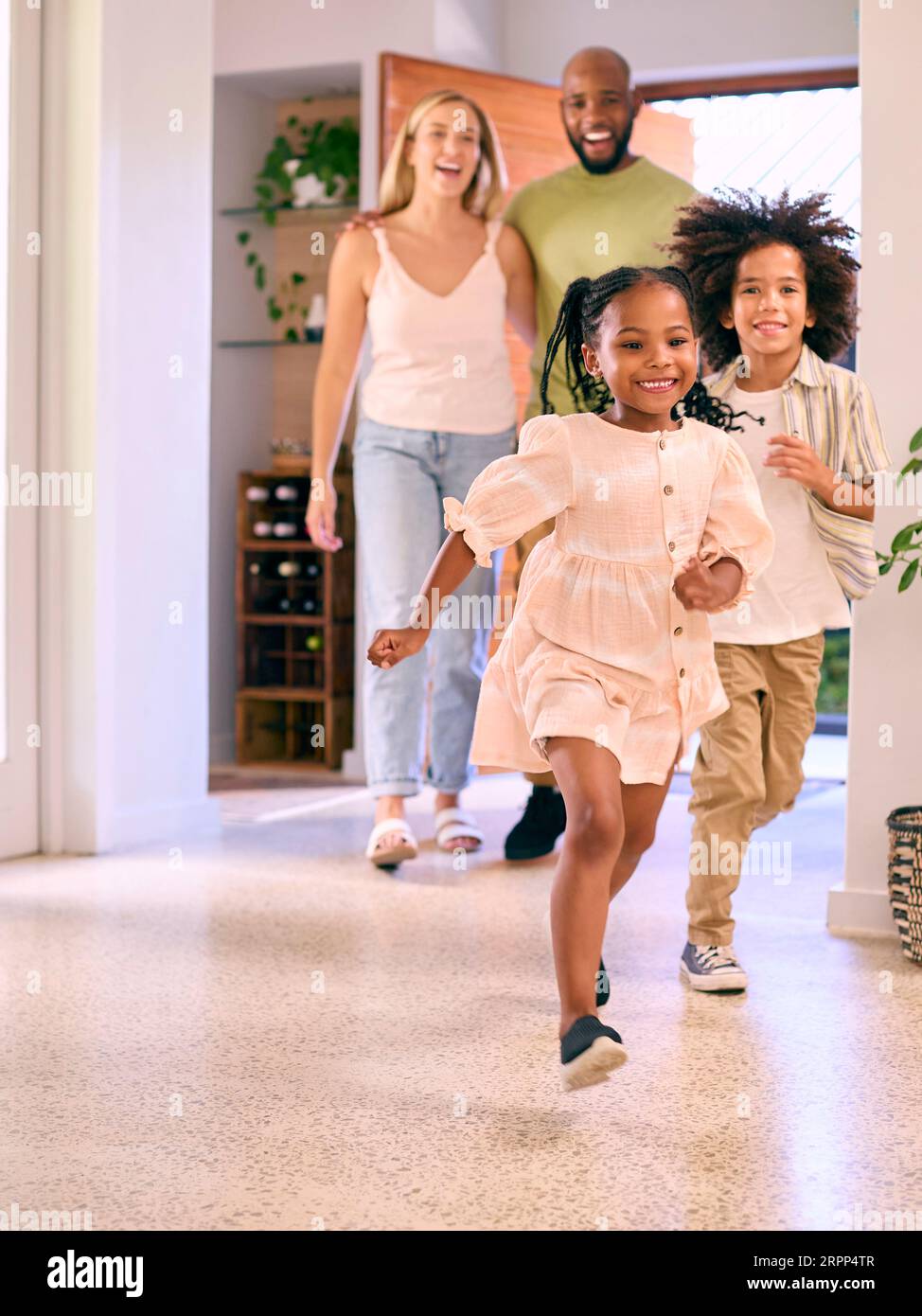 Family Returning Home Opening Front Door And Children Running In Stock ...
