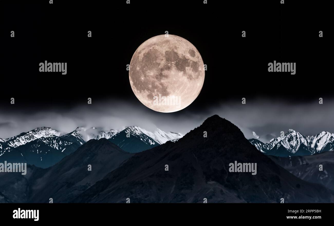 the moon over mountains landscape Stock Photo - Alamy