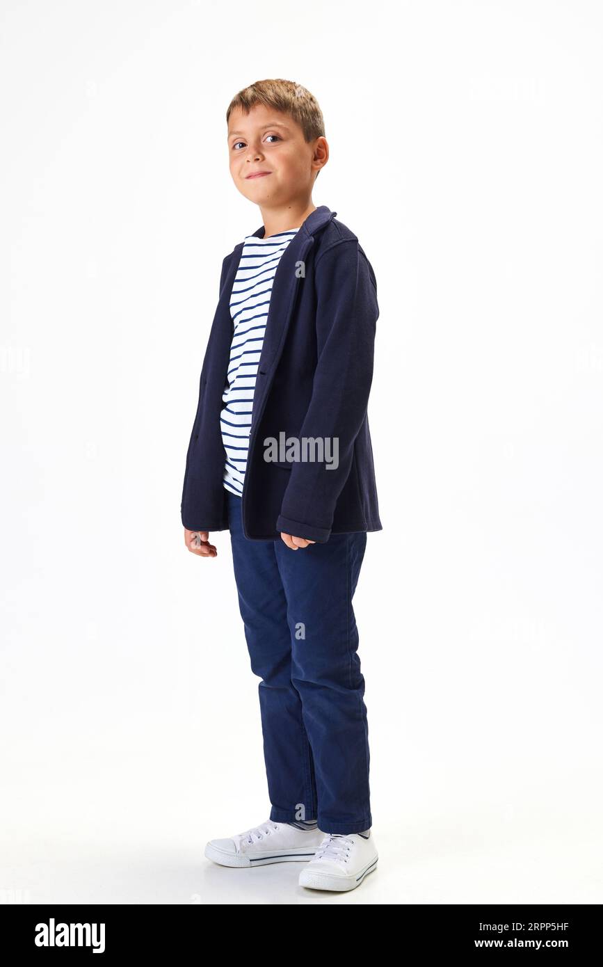 Smiling boy, child wearing blue uniform, smart casual clothes, standing ...