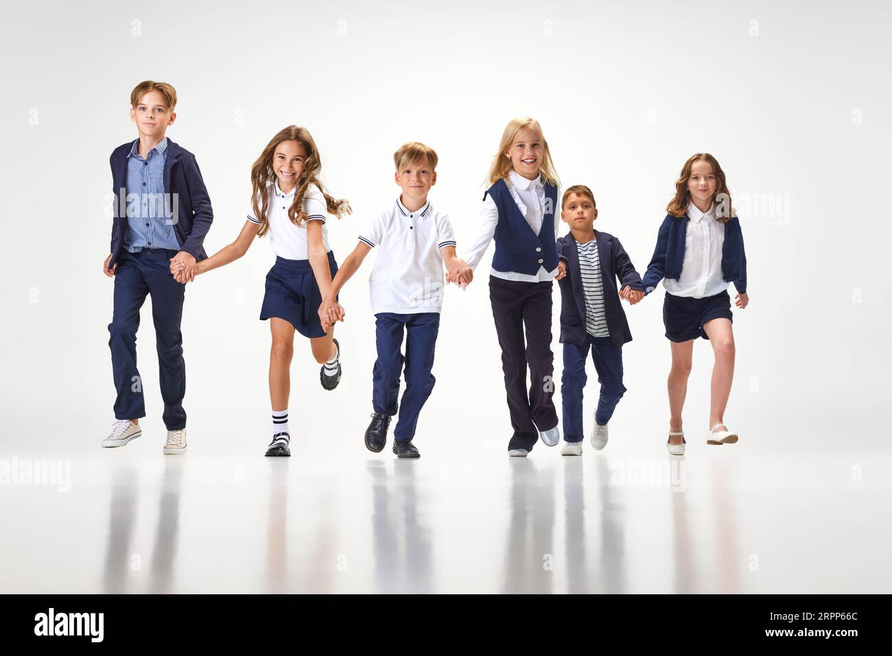 Group of stylish children, boys and girls, pupils in school uniform ...