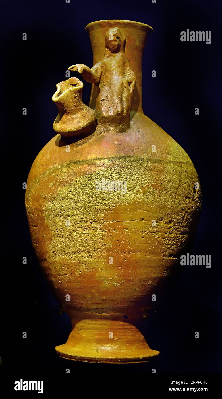Jug with attached decoration figures on shoulder Red slip and Bichrome ...
