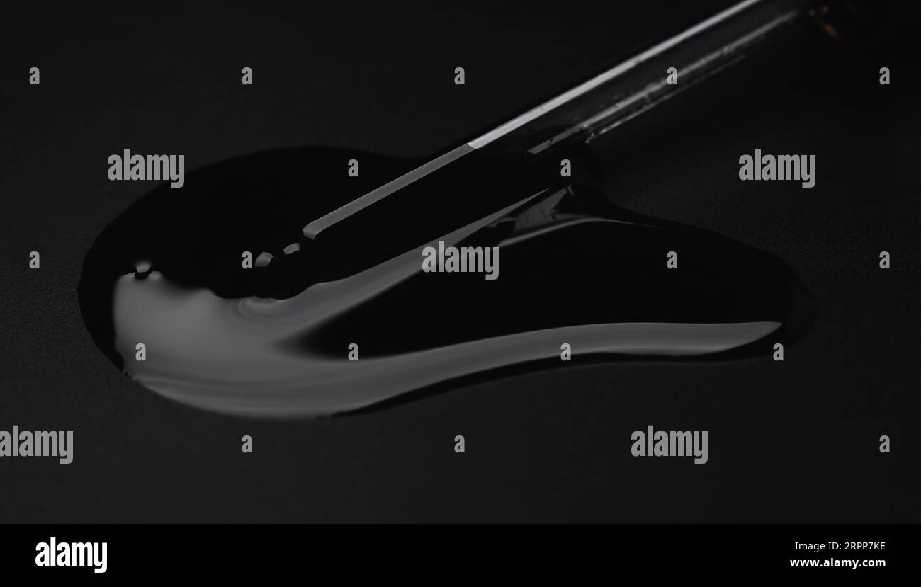 Oil and pipette on black background Stock Photo - Alamy