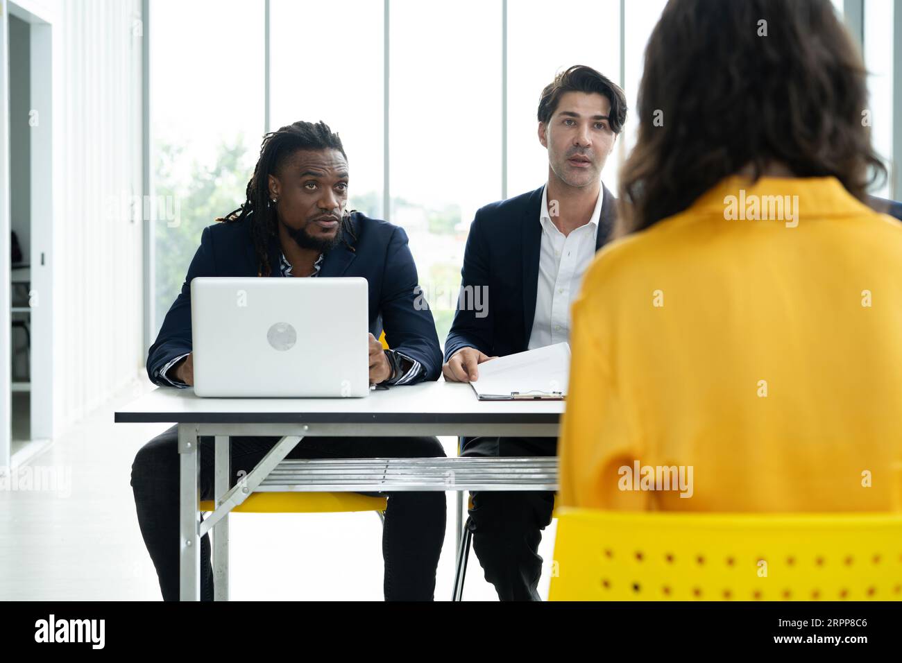 Job interview concept. Diverse hr team doing job interview with a woman in business office ...
