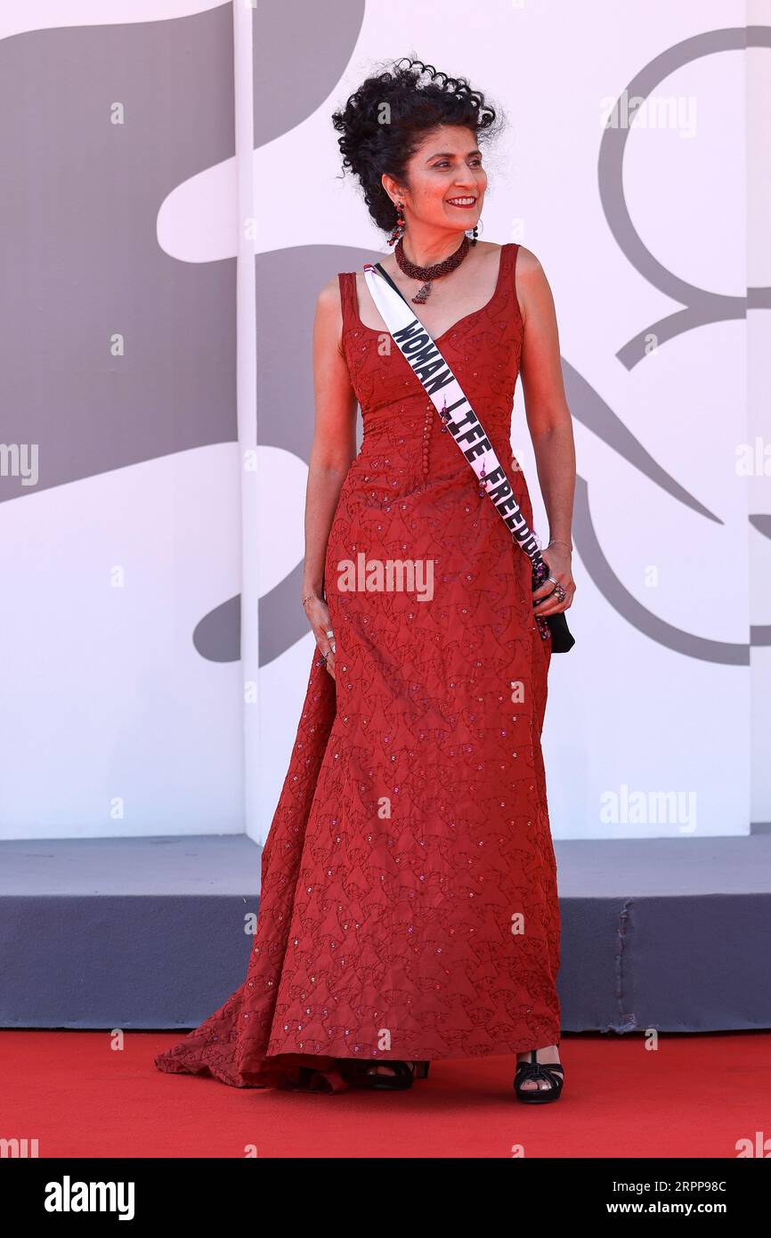 Behi Djanati wears a sash that reads 'Woman Life Freedom' as she poses ...