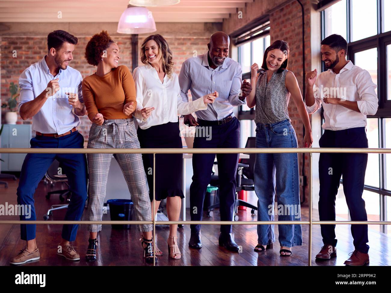 Relaxed Business Team Meeting In Busy Multi-Cultural Office With ...