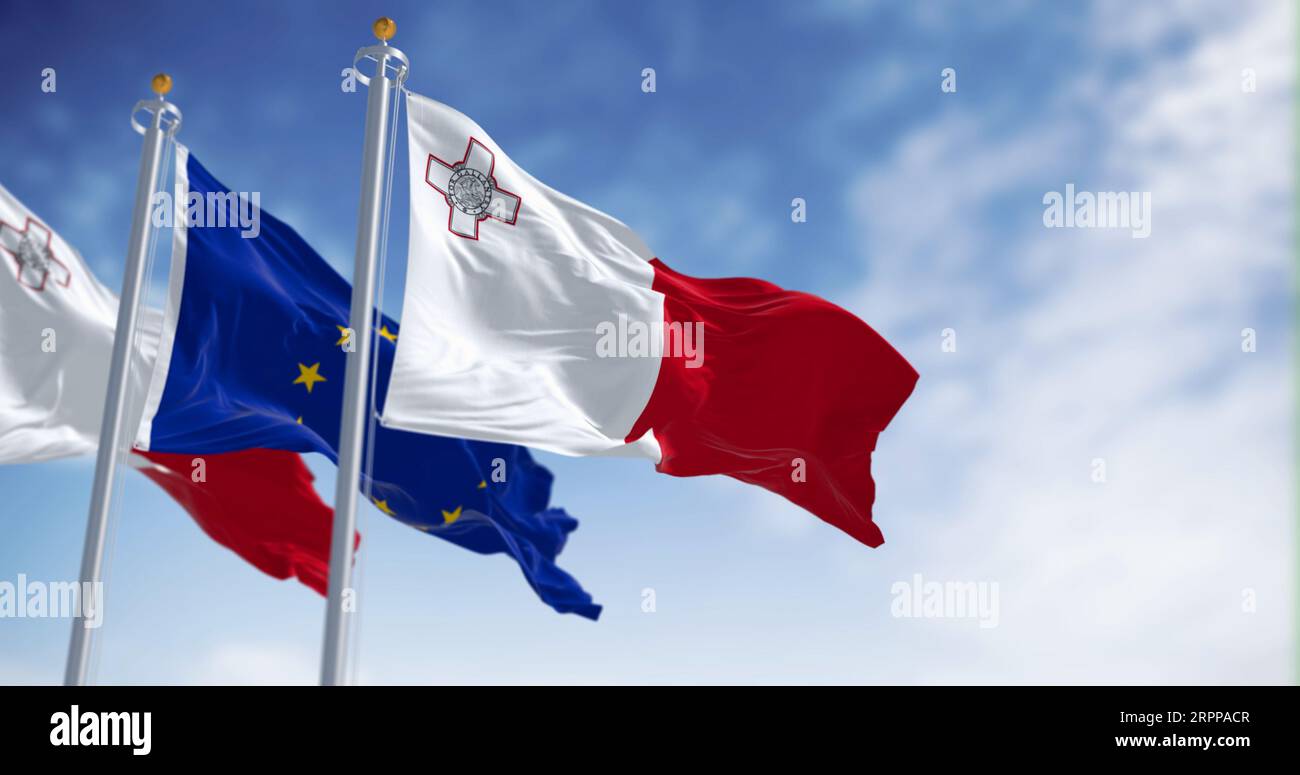 Flags of Malta and the European Union waving in the wind on a clear day ...