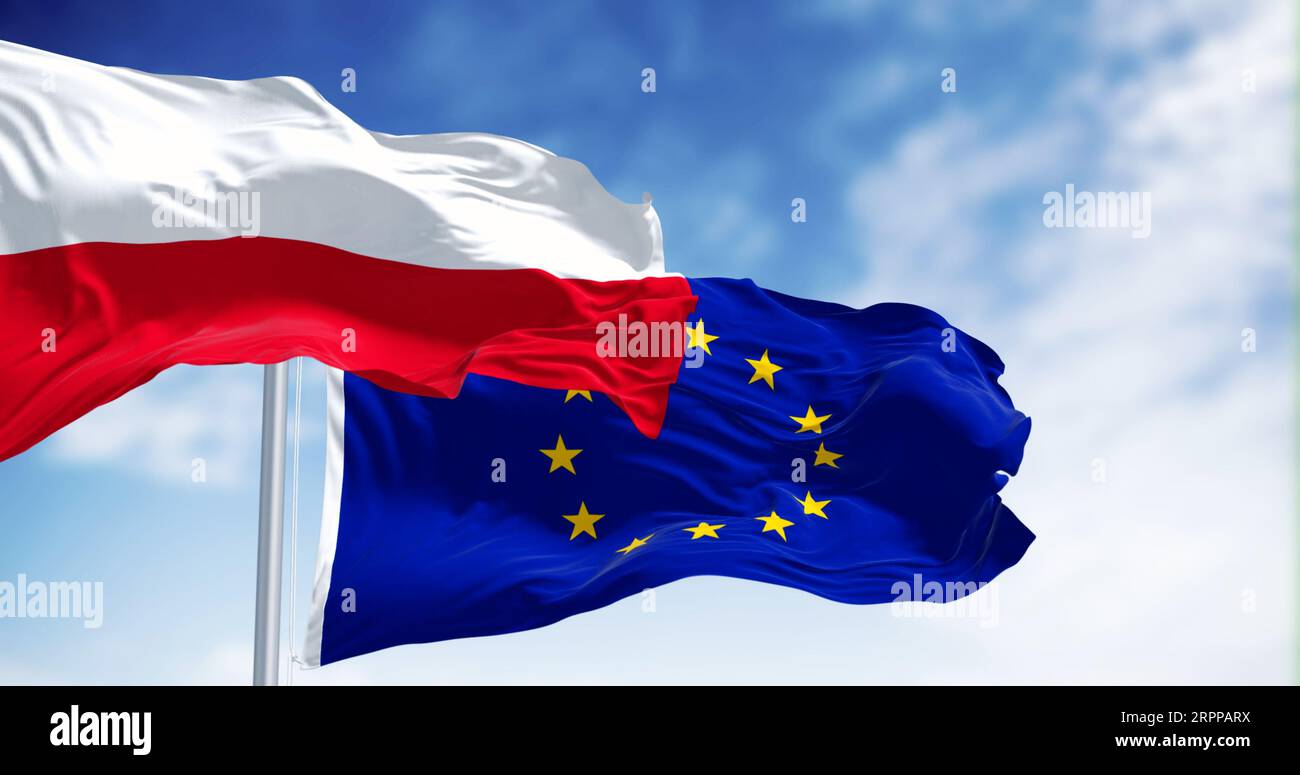 Flags of Poland and European Union waving together on a clear day ...