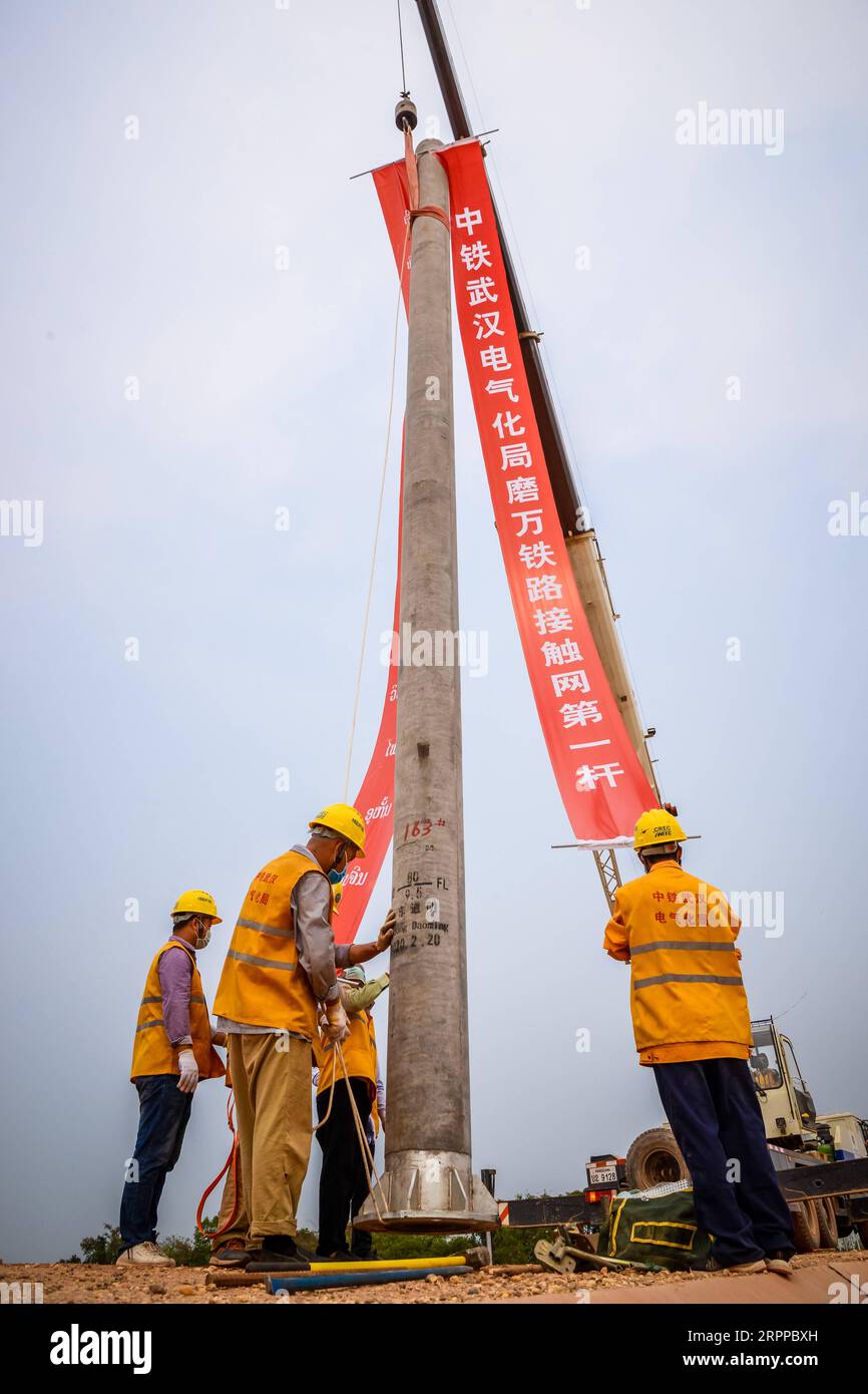 200315 -- VIENTIANE, March 15, 2020 Xinhua -- Workers plant the first ...