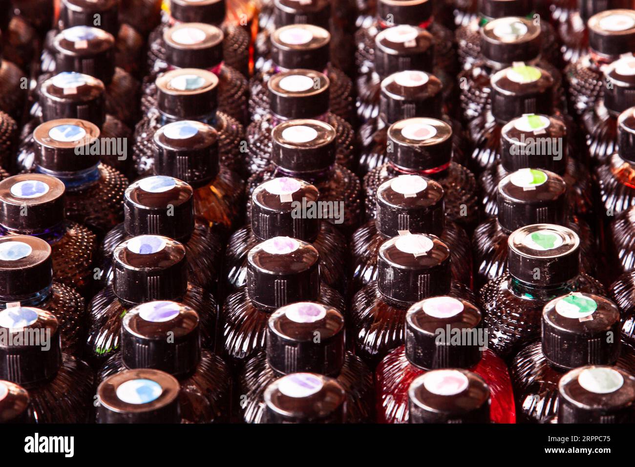 Selective focus of ink bottles in different colours. Glass bottles ...
