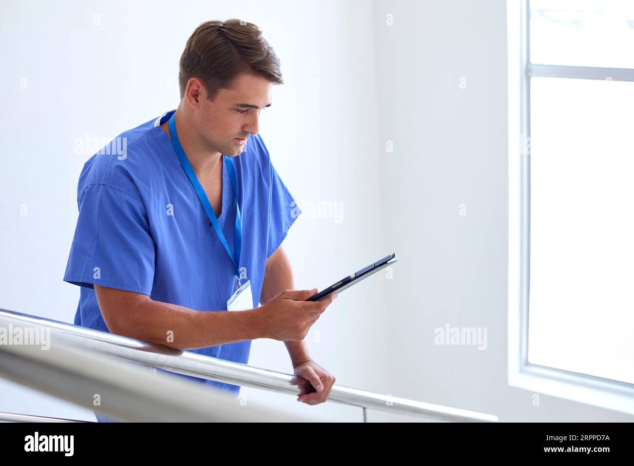 Male Doctor Or Nurse With Digital Tablet Checking Patient Notes On ...