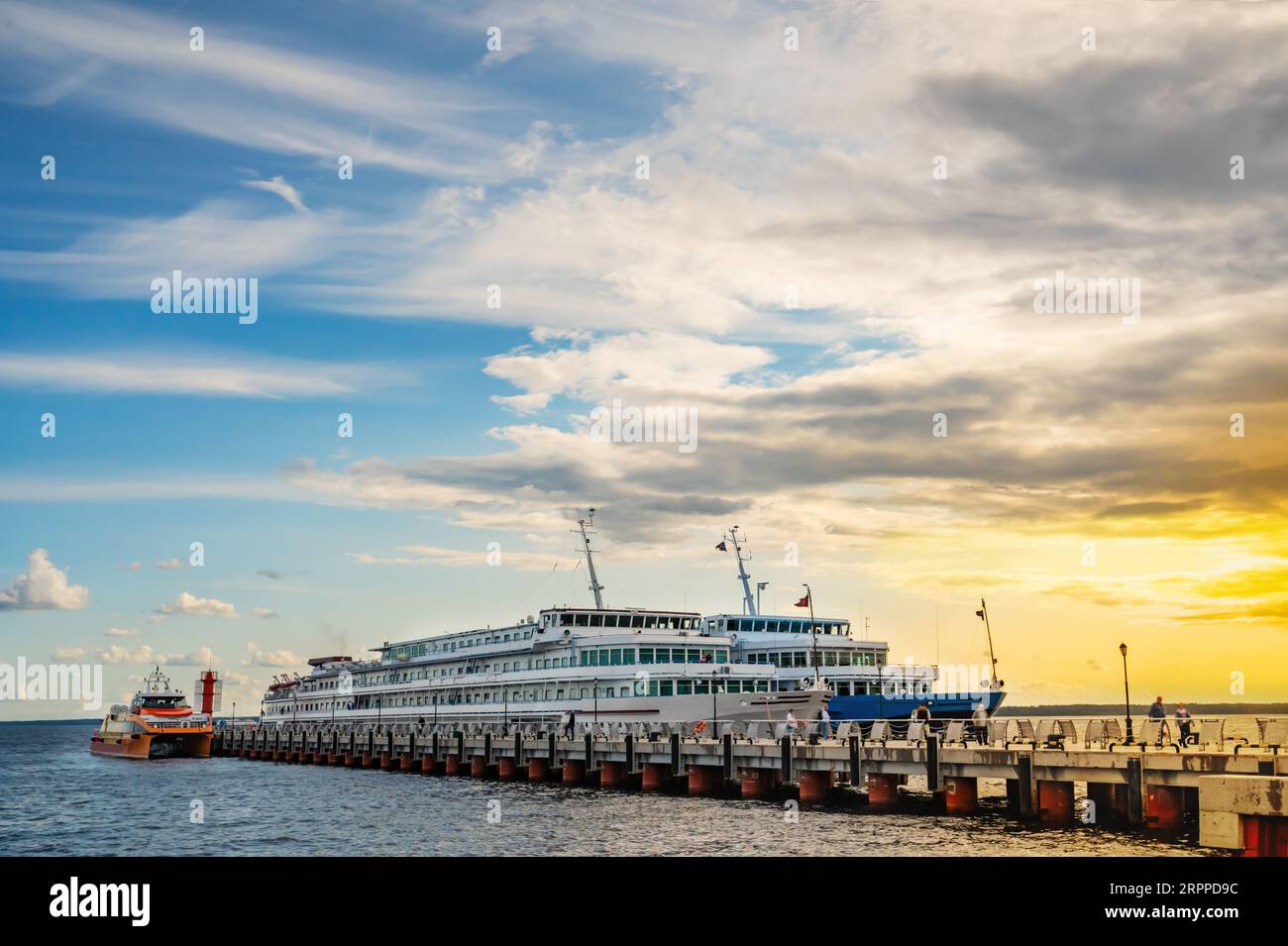 Cruise motor ships moored at the pier at sunset. Excursion tours on ...