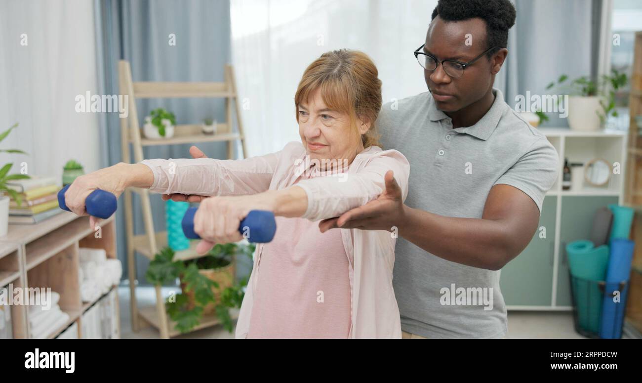 Physiotherapy, arms and senior woman with black man and dumbbell for ...