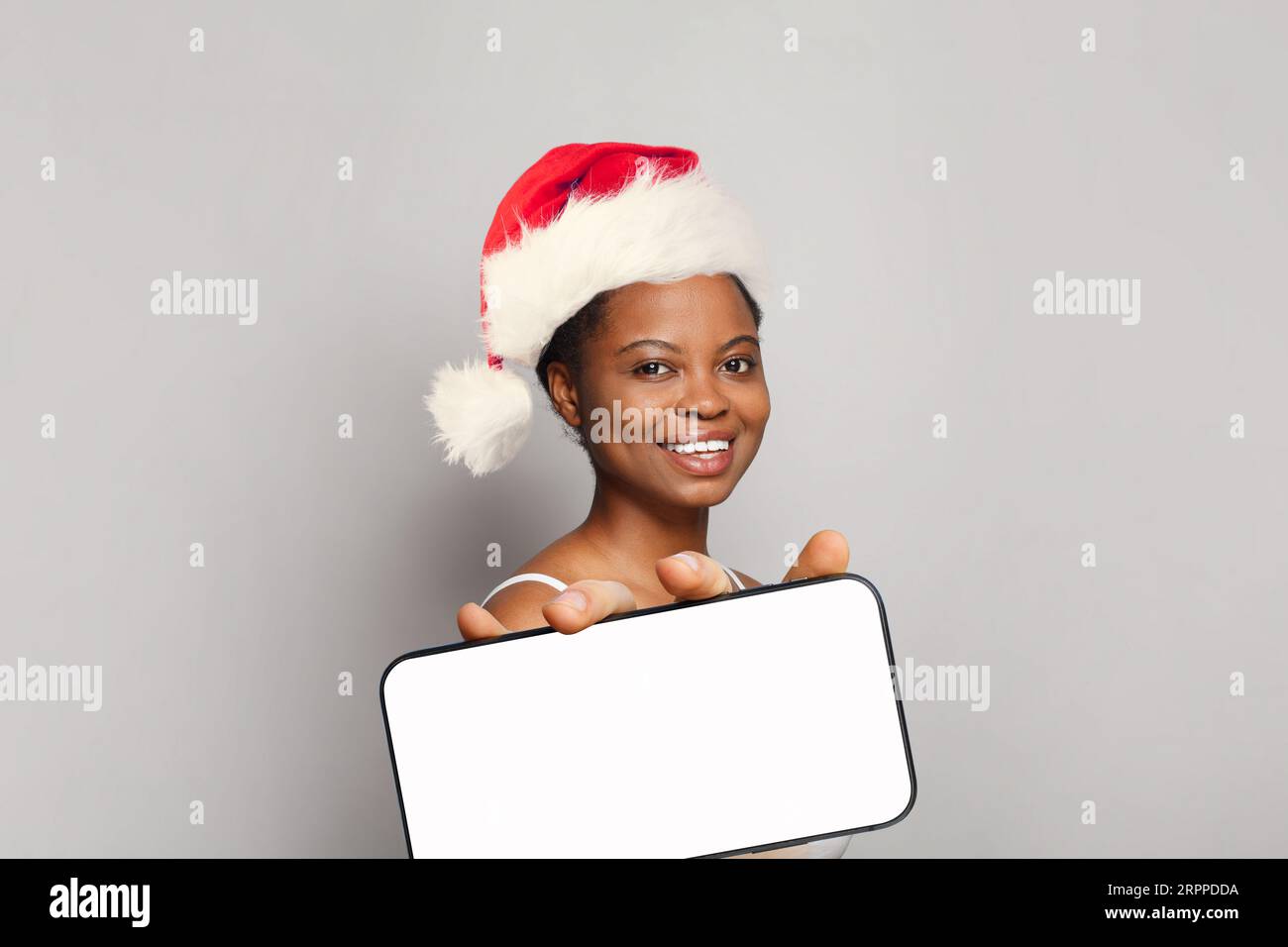 Christmas portrait of Happy Santa model woman with smartphone Stock ...