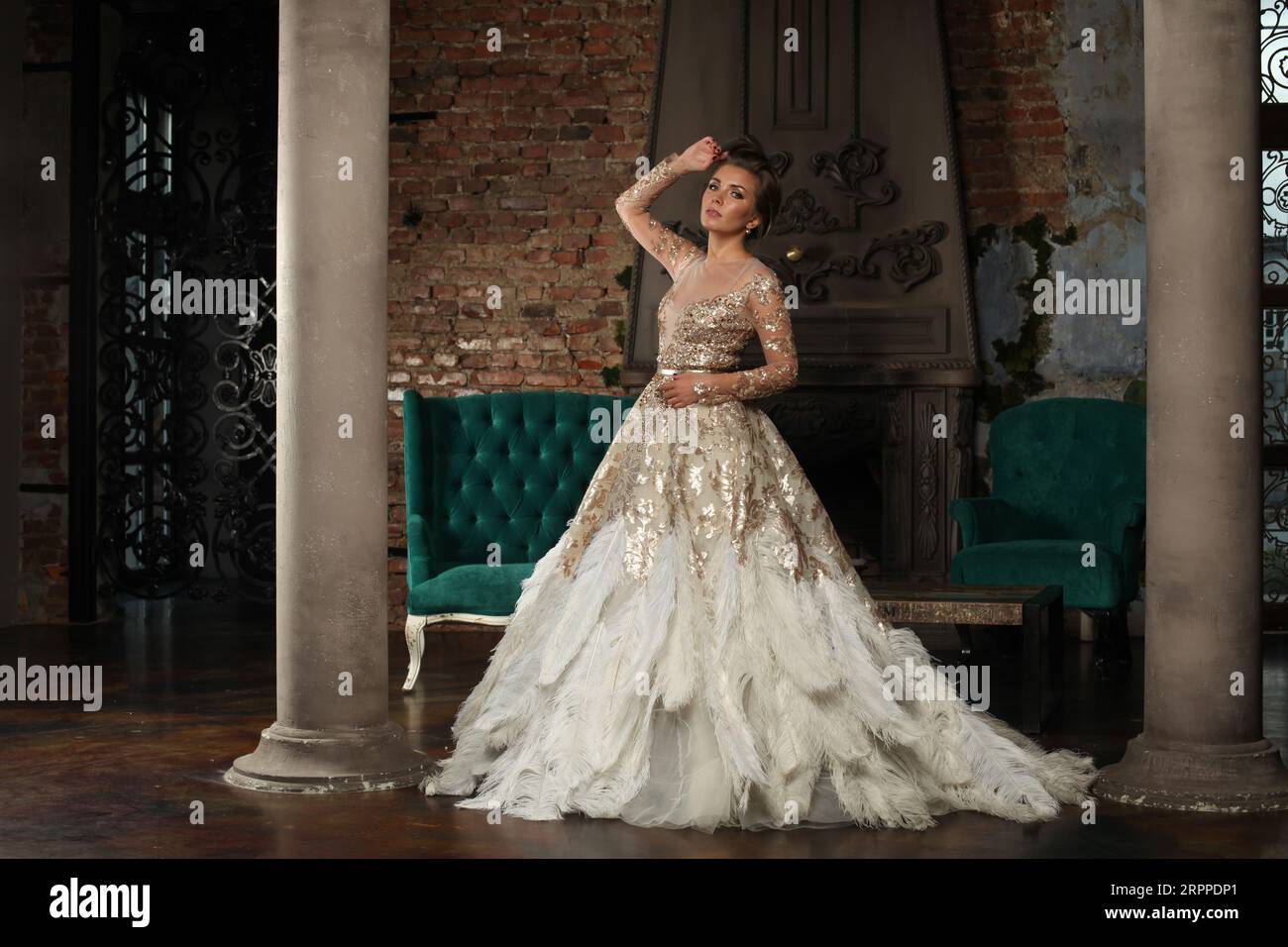 Fashion Model in Gold Long Luxury Dress. Beauty Woman dancing over ...