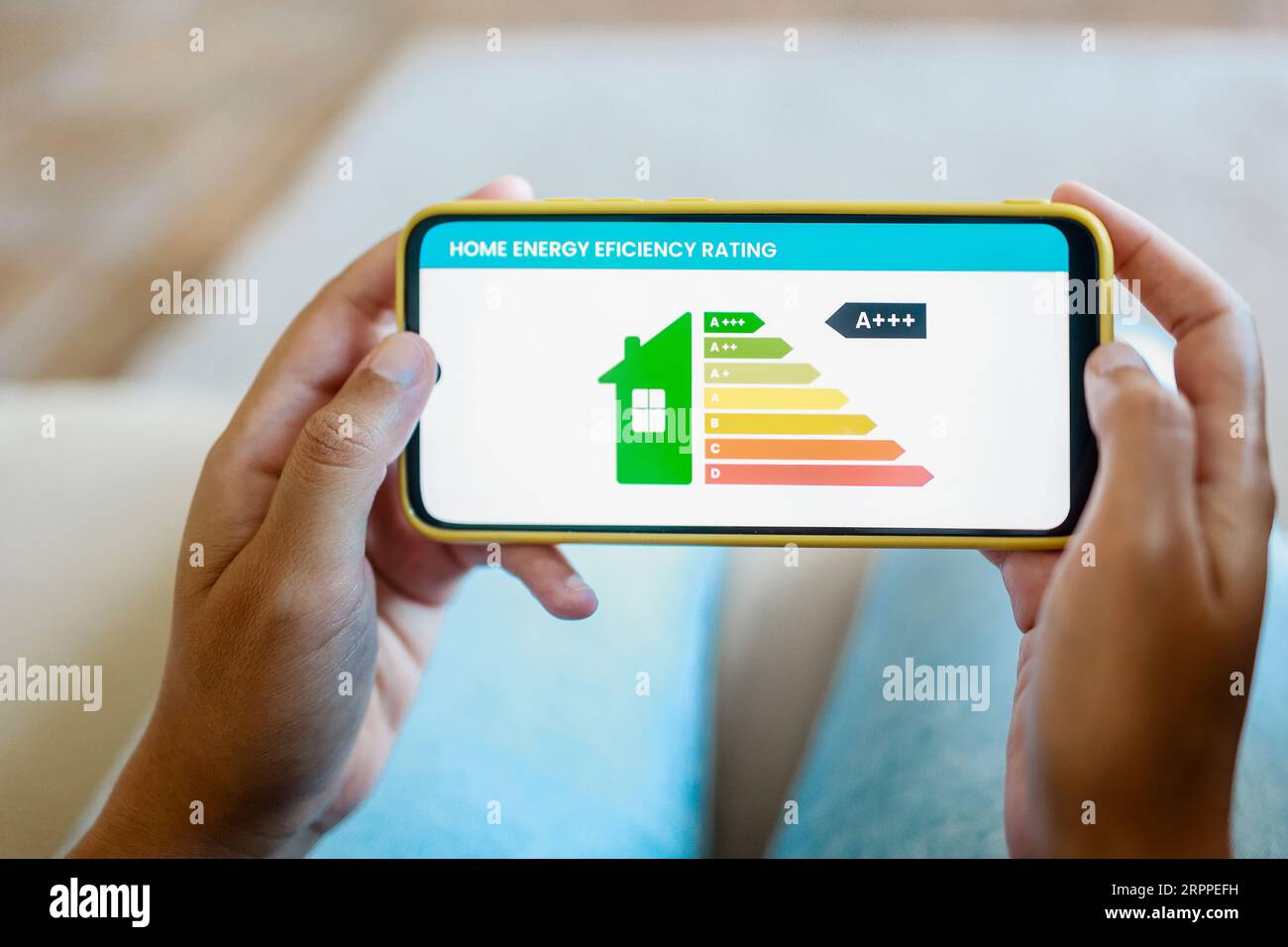 Home energy performance: Hands hold mobile phone looking at house ...